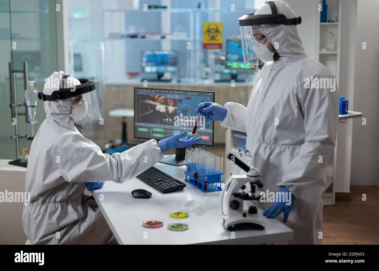 Scientists wearing ppe medical suit against covid19 examining infected ...