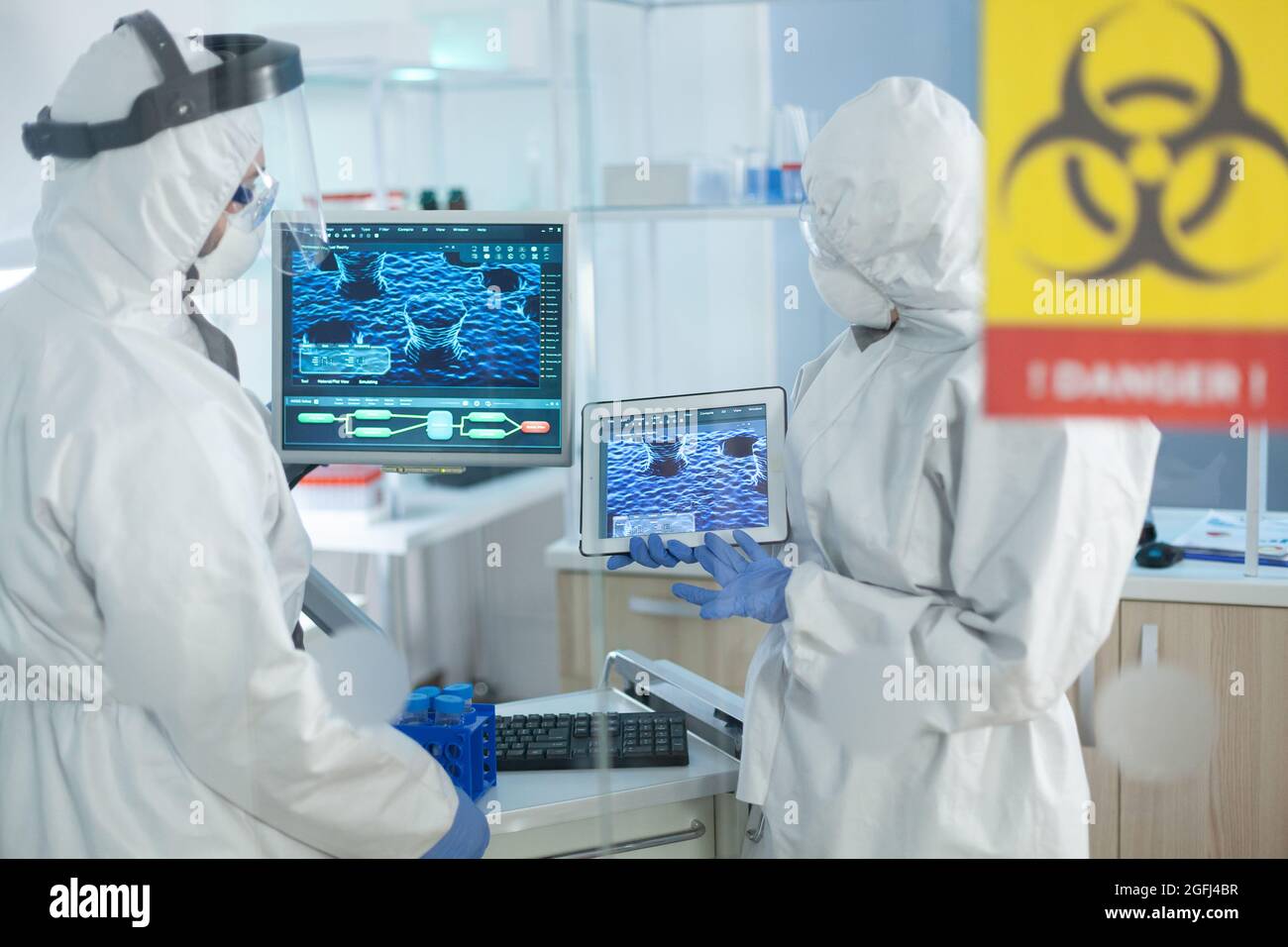Medical teamwork of scientists wearing protective suit analyzing virus ...