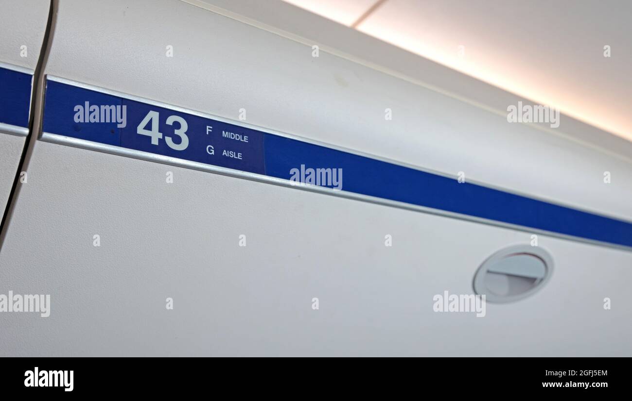 Hand-luggage compartment in airplane - Carry-on luggage in row 43 Stock ...