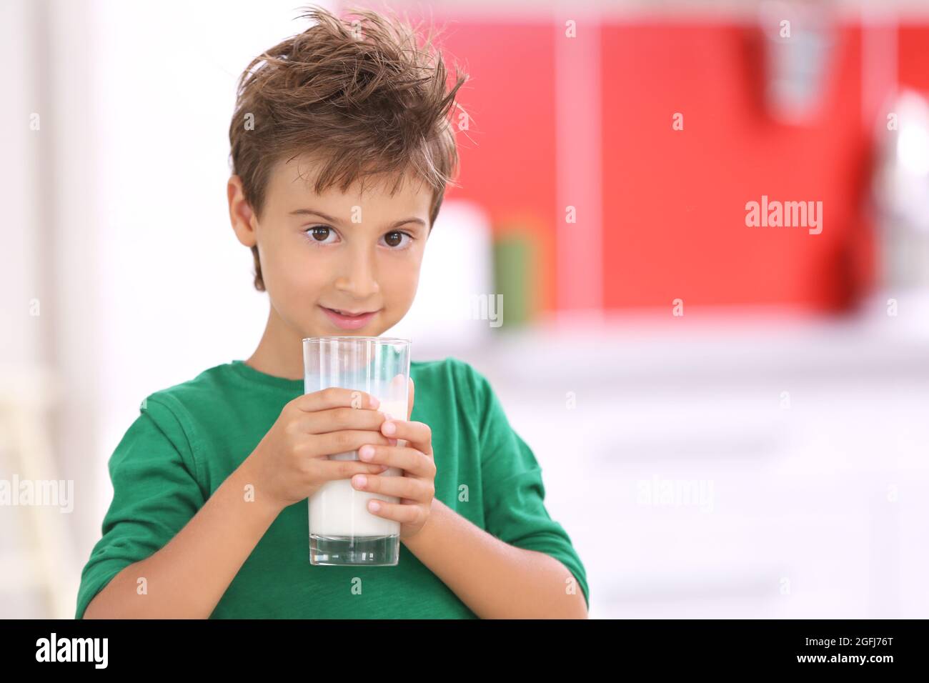 Little kid with glass of milk at kitchen Stock Photo - Alamy