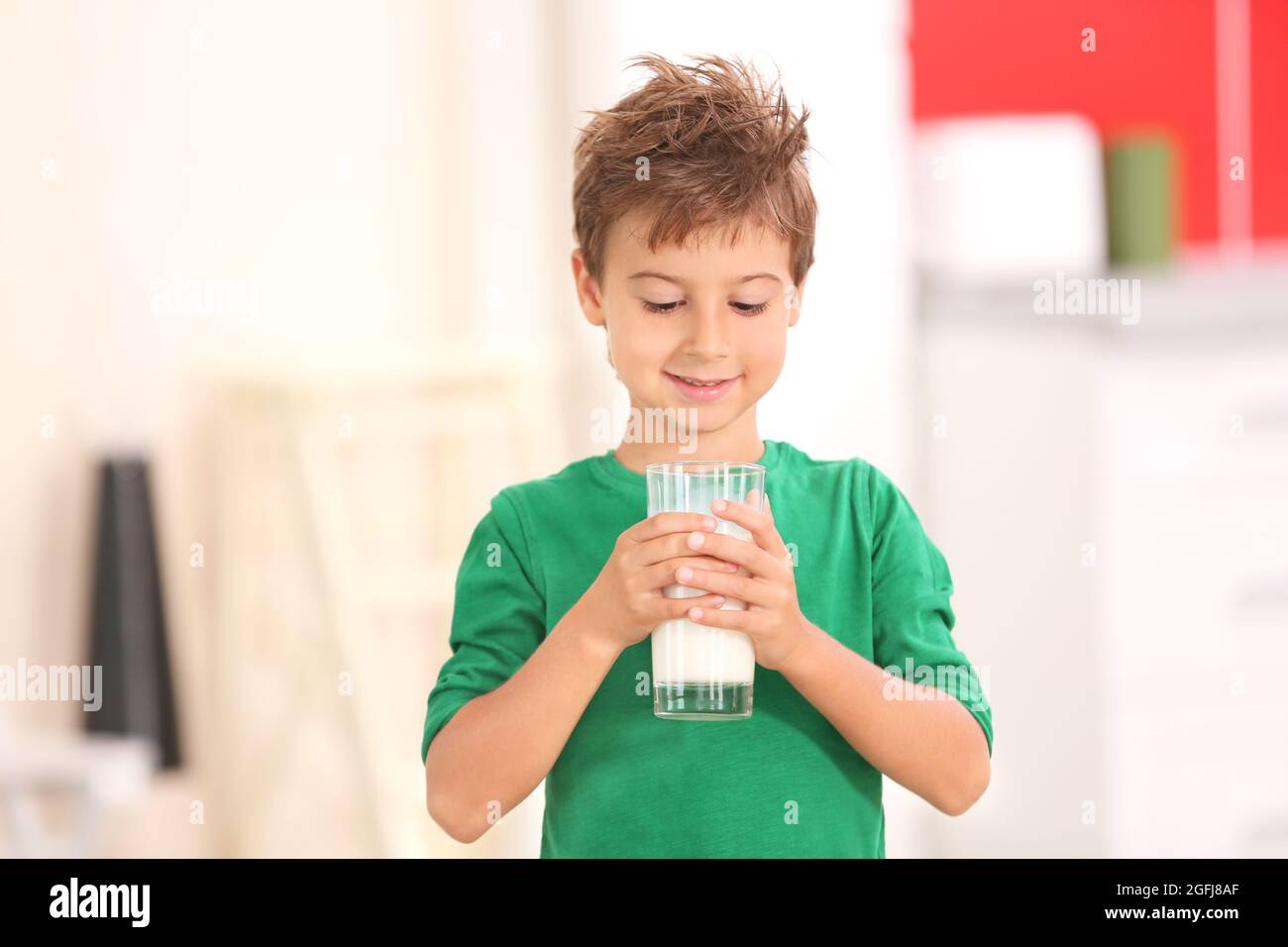 Little kid with glass of milk at kitchen Stock Photo - Alamy