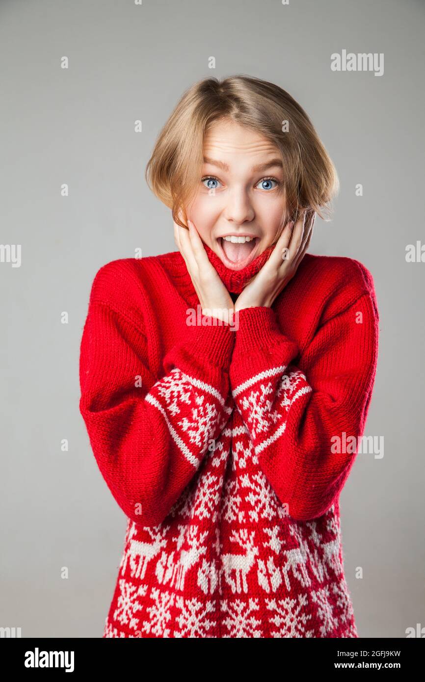 Girl wrapped in a warm knitted sweater Stock Photo - Alamy