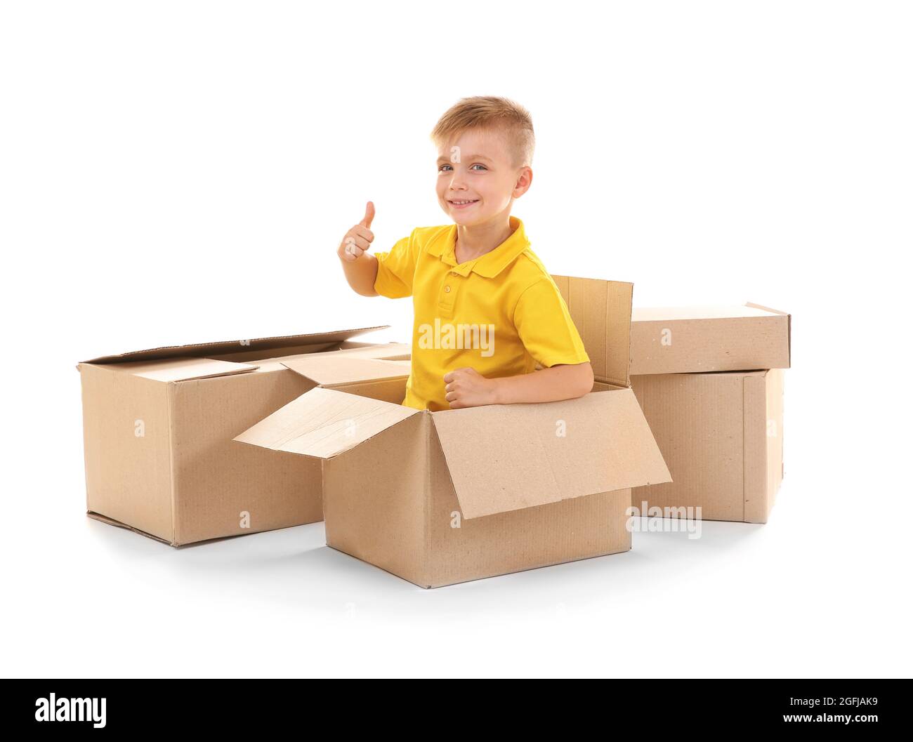 Little boy playing with cardboard boxes isolated on white Stock Photo ...