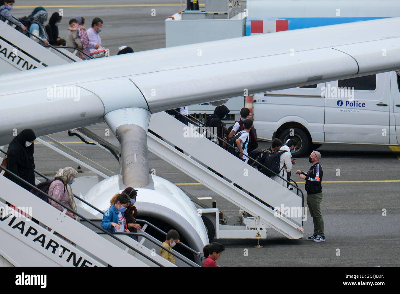 Illustration picture shows people getting out of the plane next to a ...