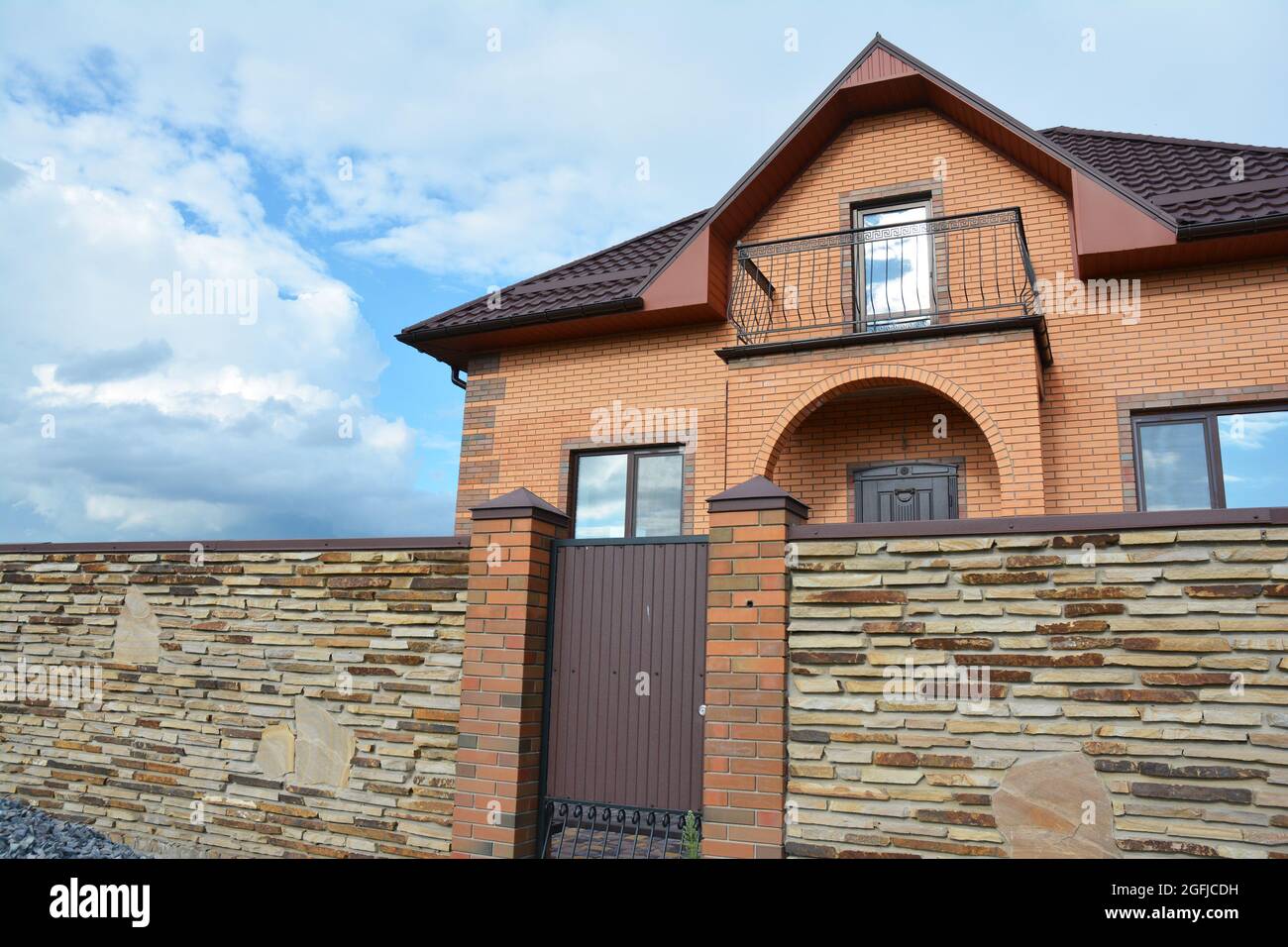 Modern brick house construction with bonnet rooftop covered with metal ...