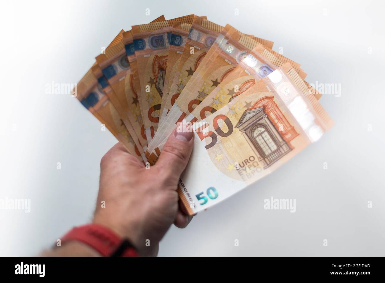Male hand holds European money Euro on white background: 50 euro ...