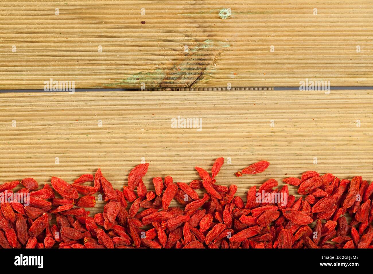 Goji berries on wooden surface Stock Photo - Alamy