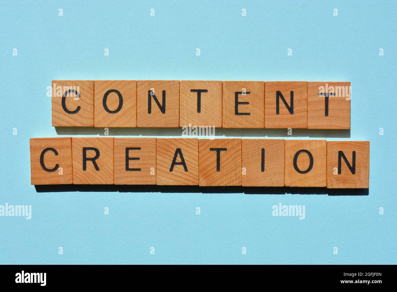 Content Creation, words in wooden alphabet letters isolated on blue ...
