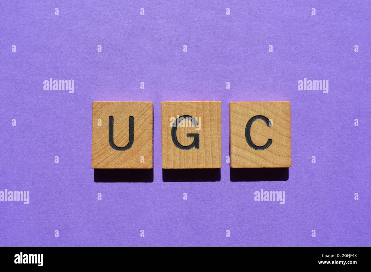 UGC, acronym for User Generated Content in wooden alphabet letters ...