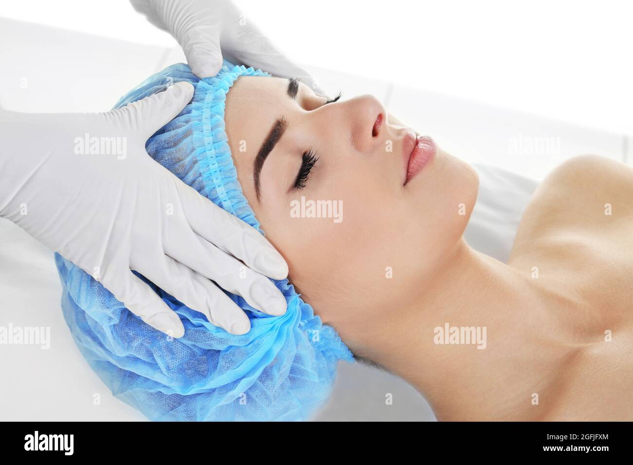 Plastic surgery concept. Doctor checking female face before plastic ...