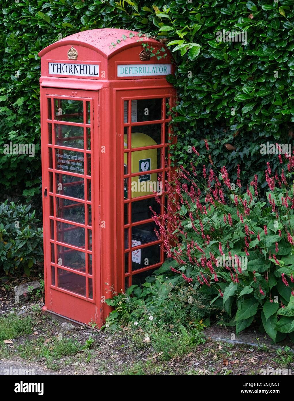 A red former telephone box now converted into a defibrillator in a ...
