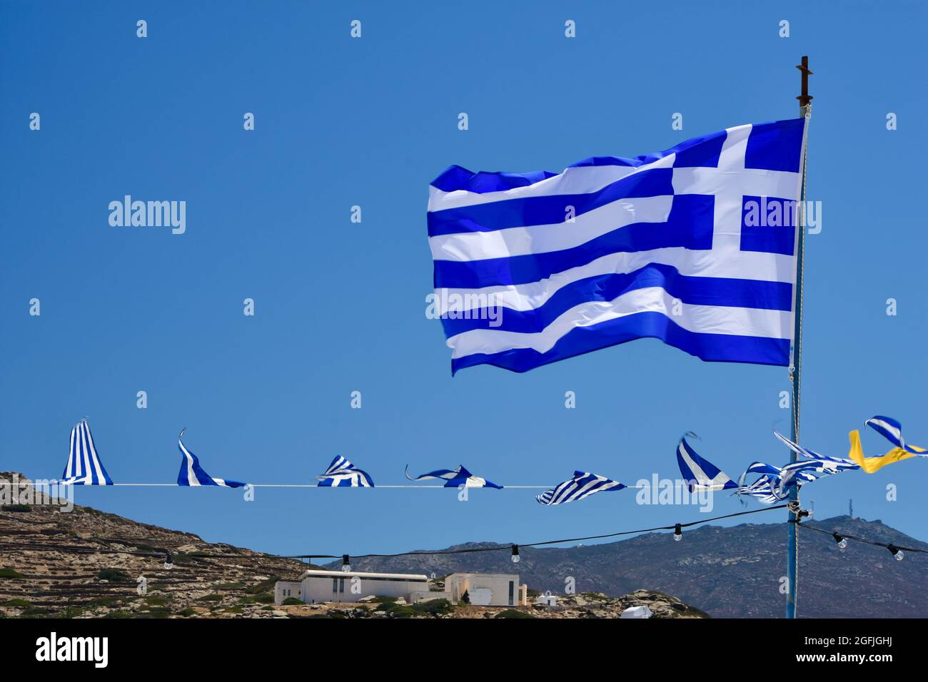 A Greek flag on the Cycladic island of Ios in the Aegean Sea, Greece ...