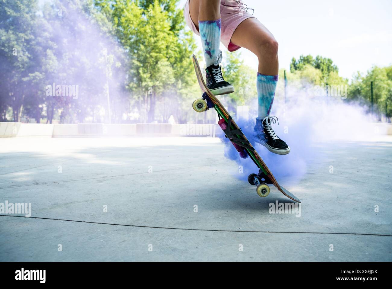 skaters with colored smoke bombs. Professional skateboarders having fun ...