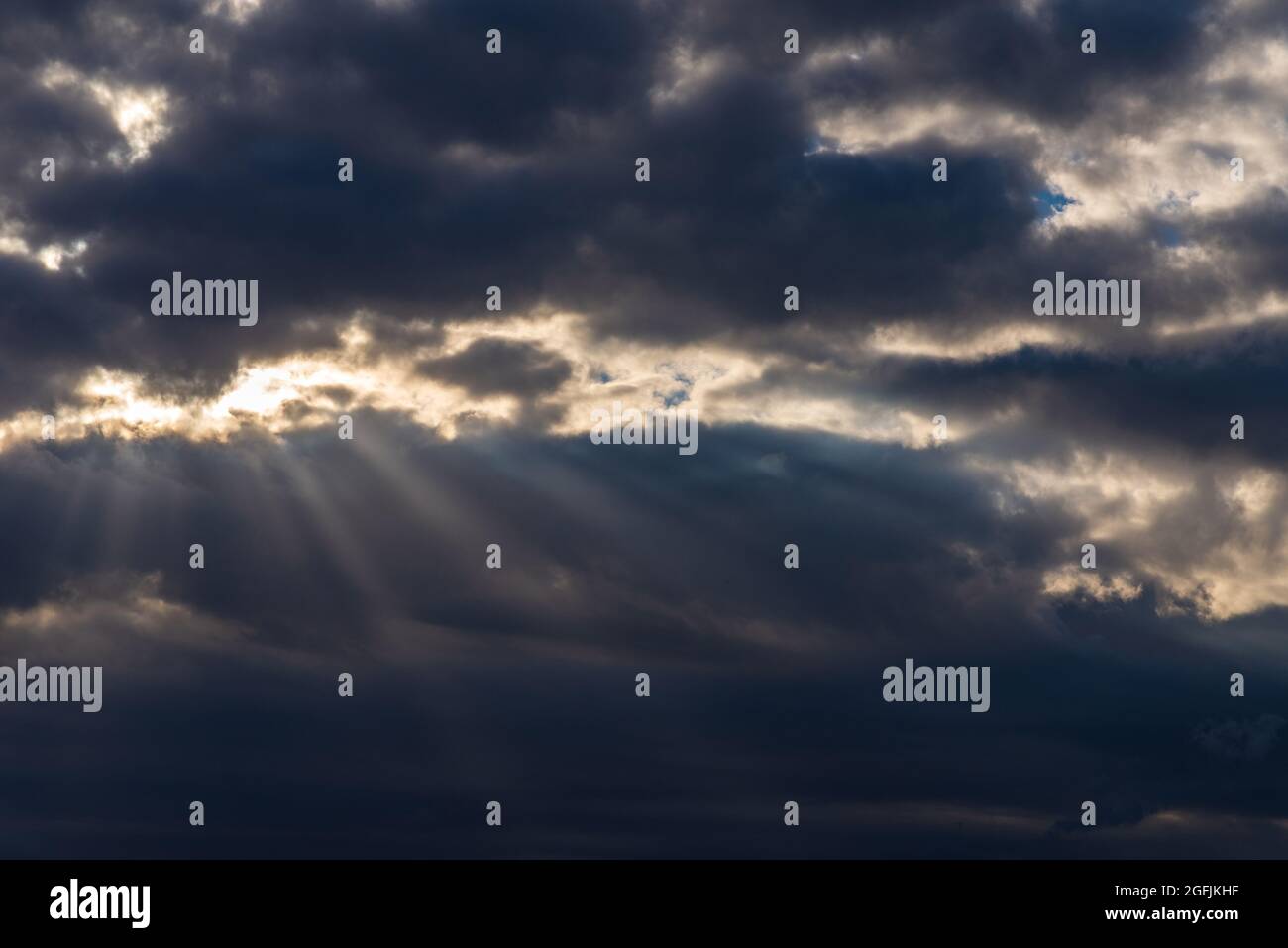 Rays of light shining throug dark clouds.Beautiful dramatic sky with ...
