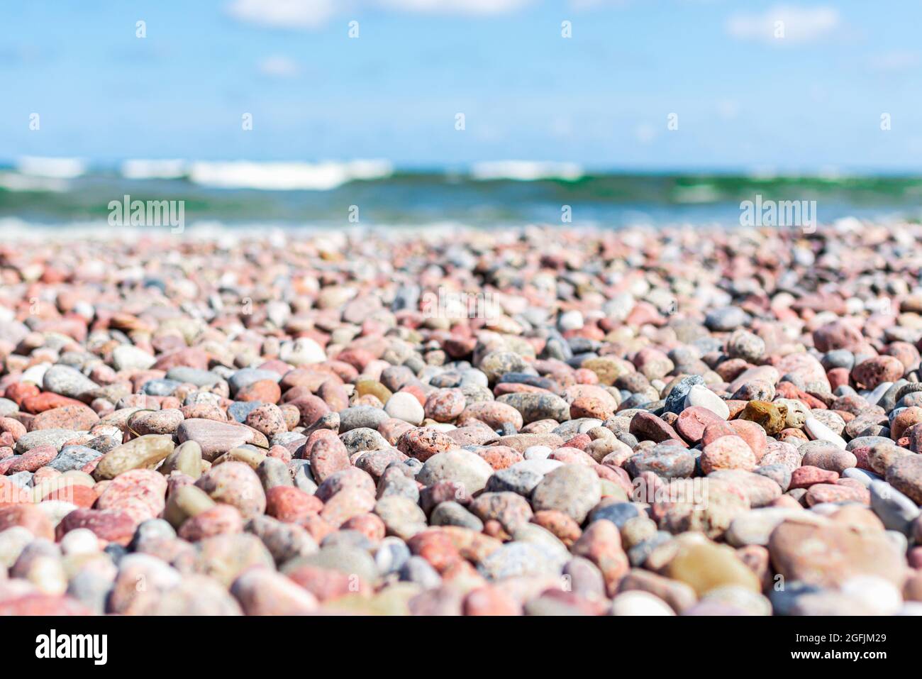 Small pebbles on the shore. sunny summer day blue sky,white clouds ...