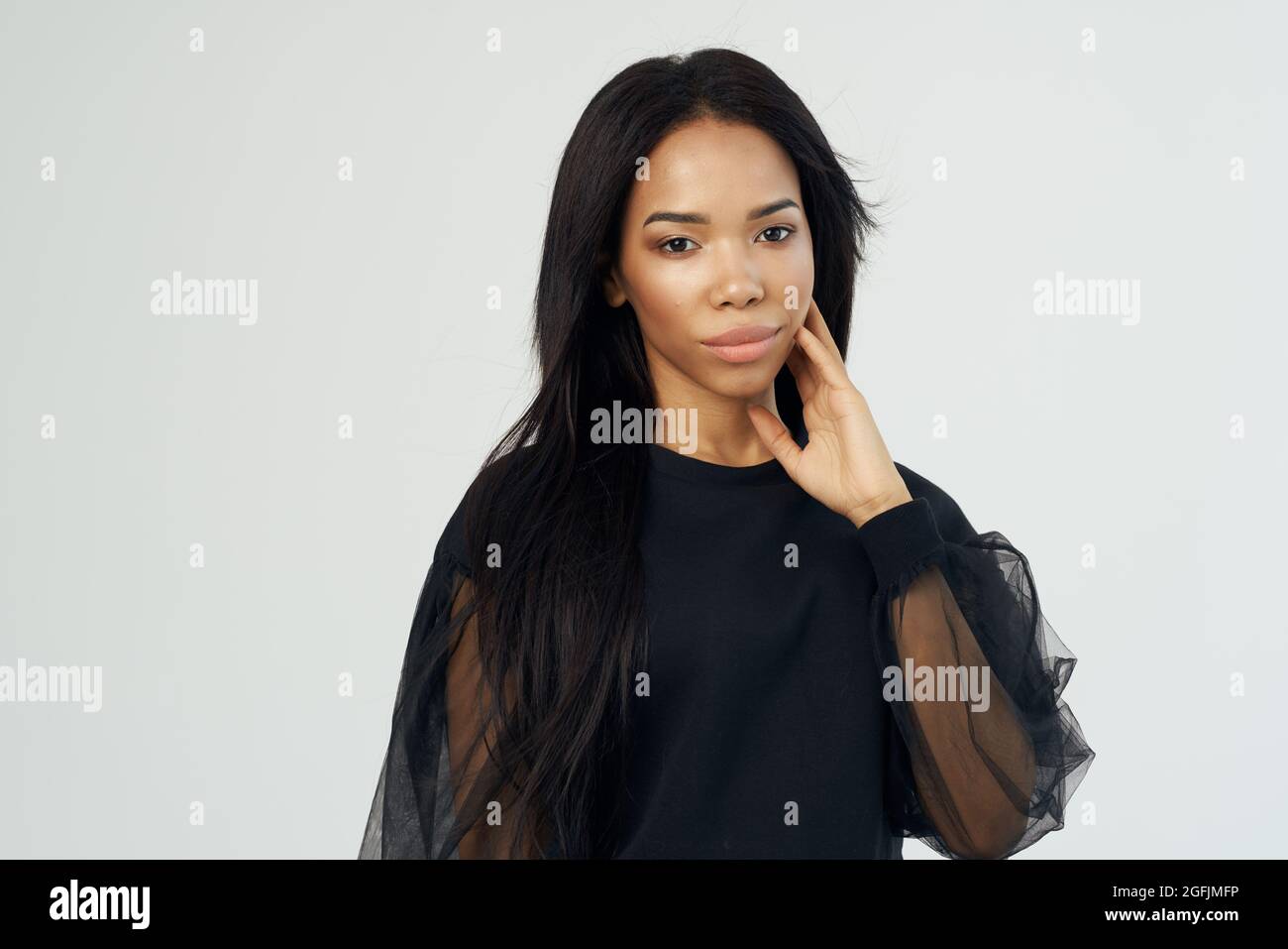 woman african appearance and long dark hair posing studio Stock Photo ...