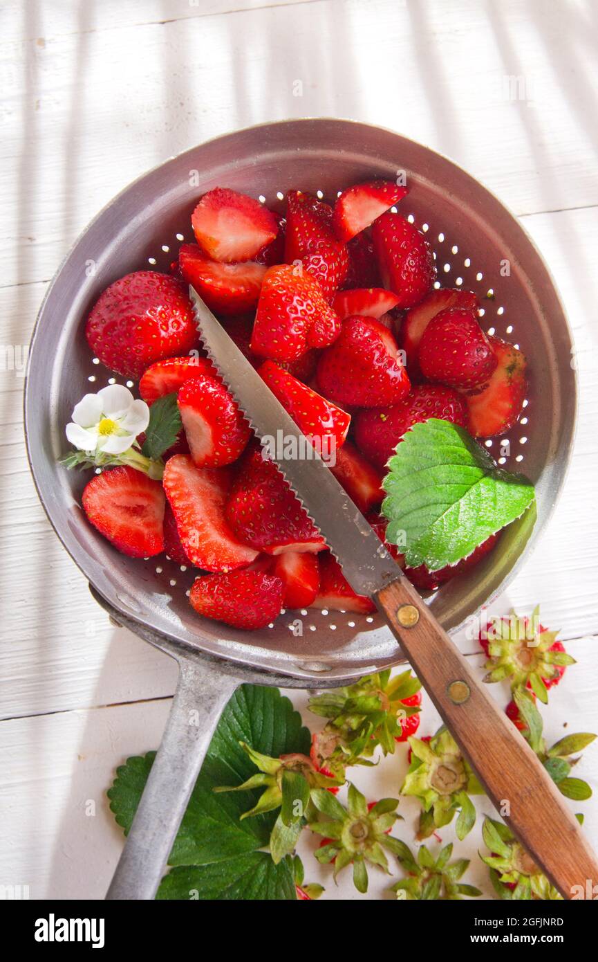 Preparing a fruit salad, strawberries into small pieces Stock Photo - Alamy