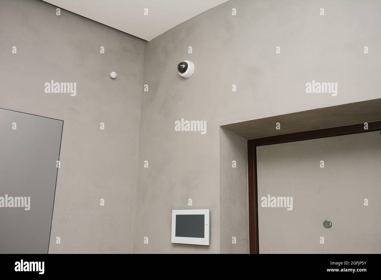 Entrance hall with a metal entrance door, smart house system and a ...