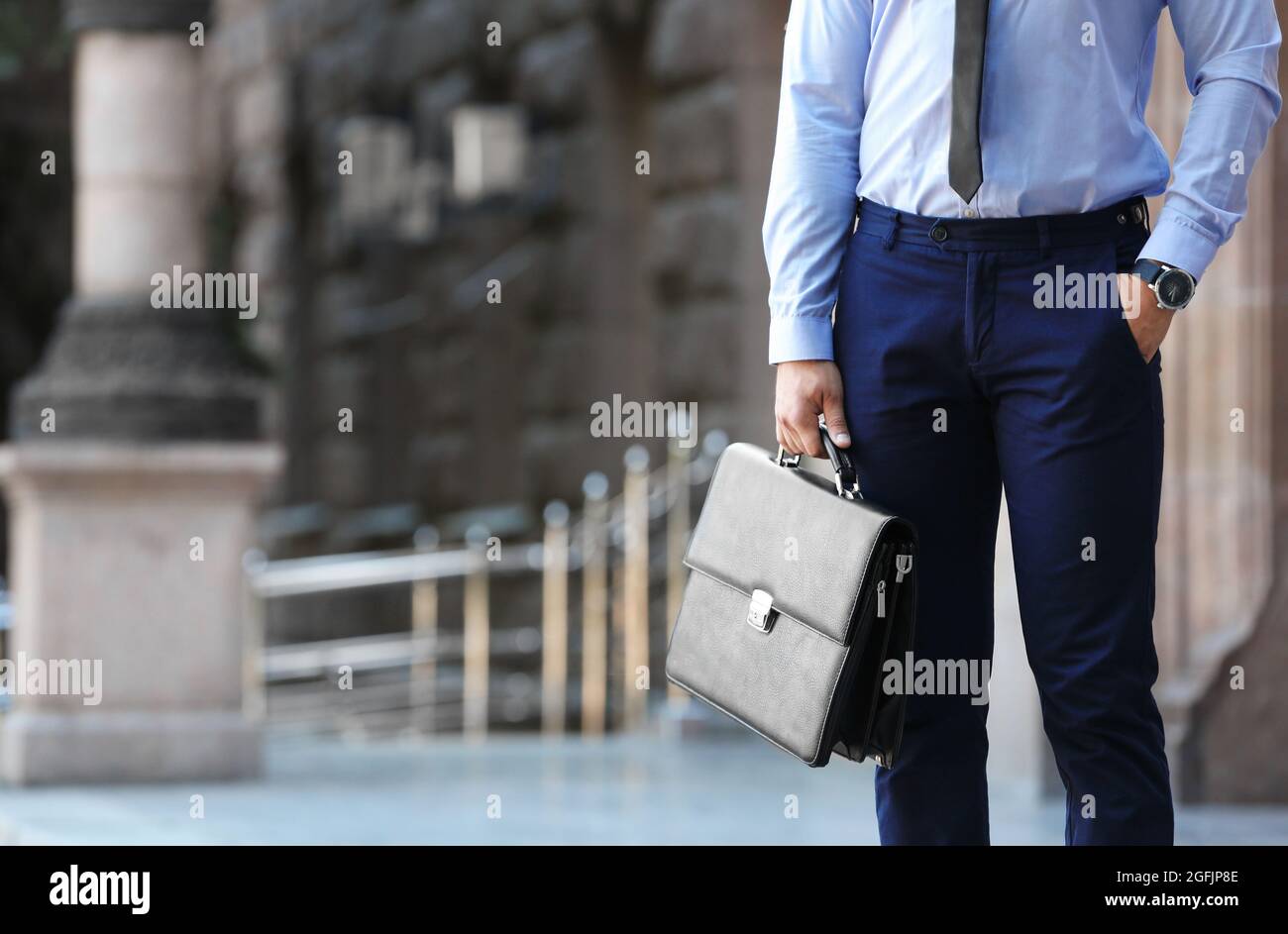 Lawyer holding briefcase on the street Stock Photo - Alamy