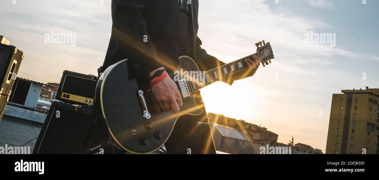 Guitarist playing outdoors Stock Photo - Alamy