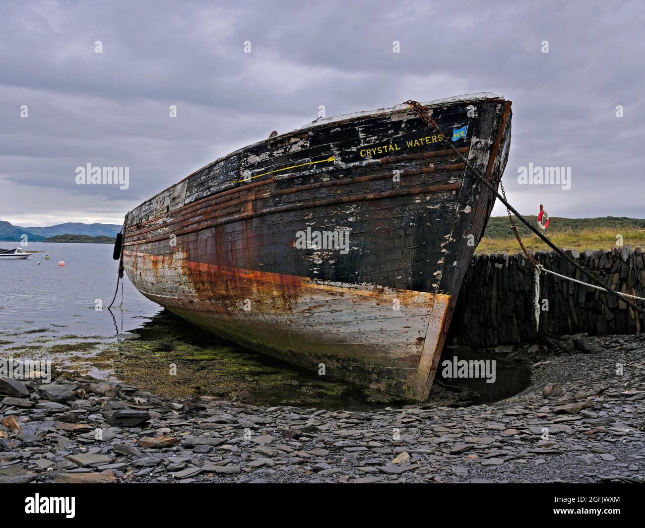 Wrecked boat on the beach on Luing island Stock Photo - Alamy
