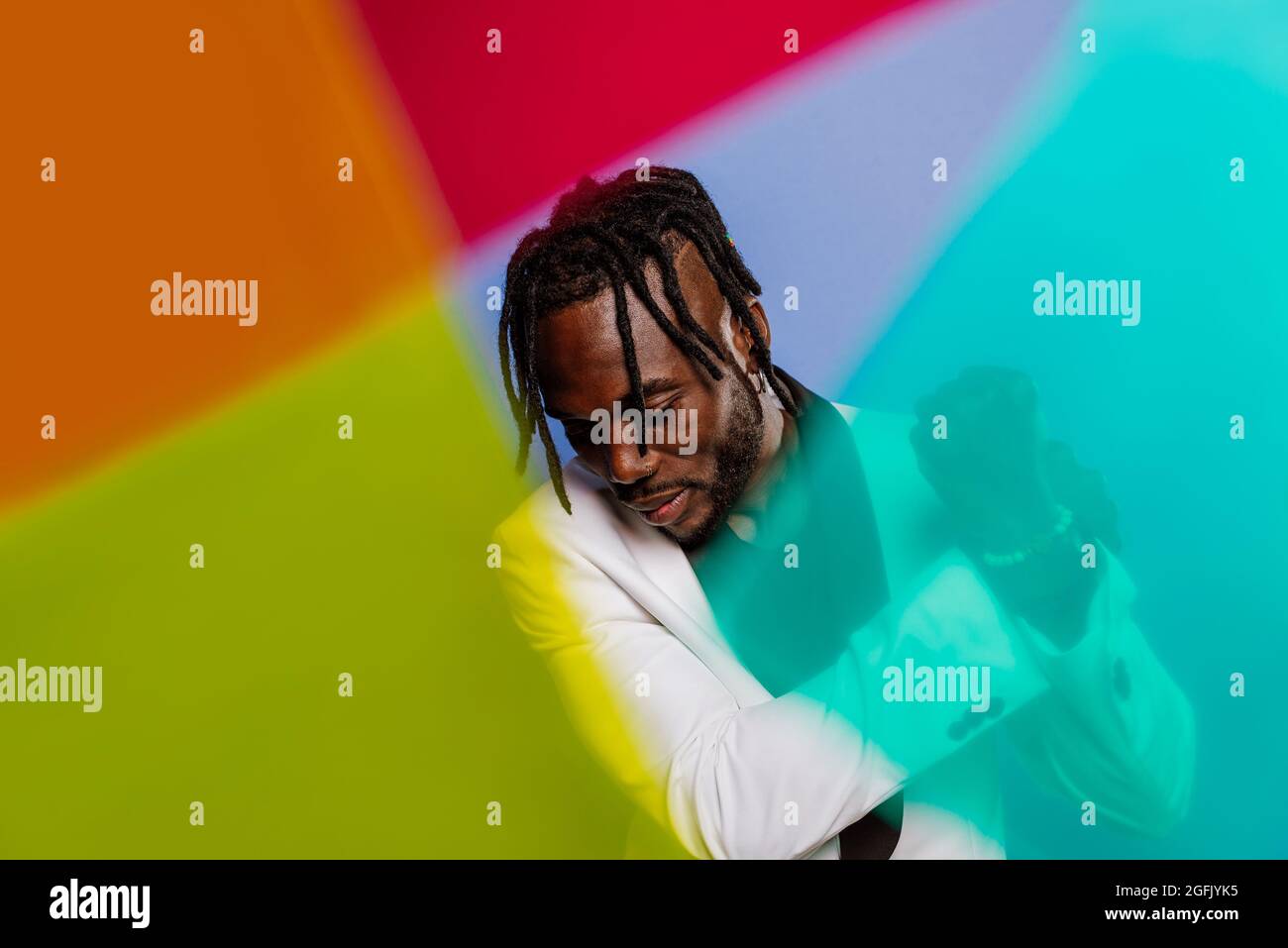 Artistic portrait with gel lights. Handsome man posing on colored ...