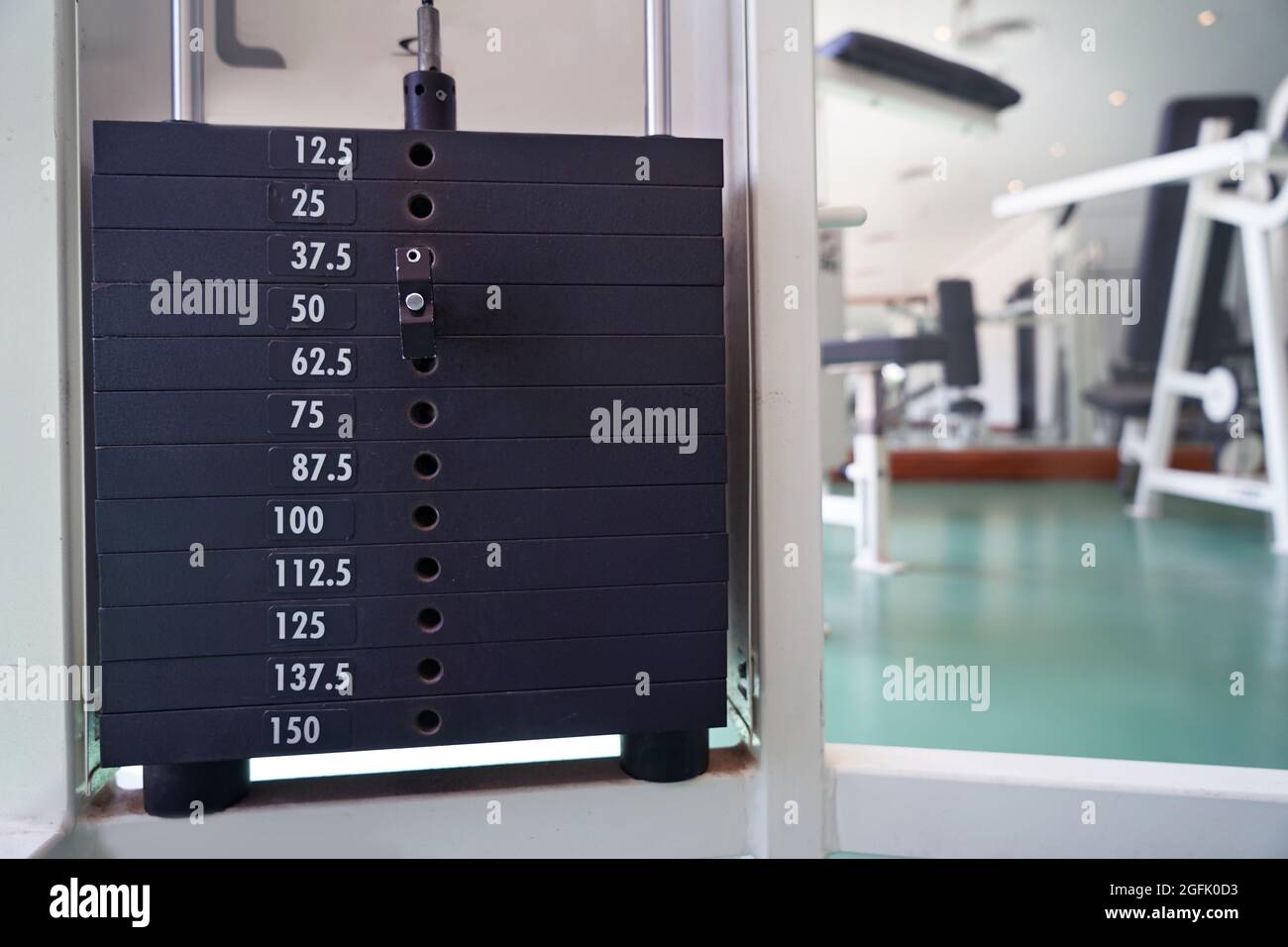 Weight stack in gym Stock Photo - Alamy