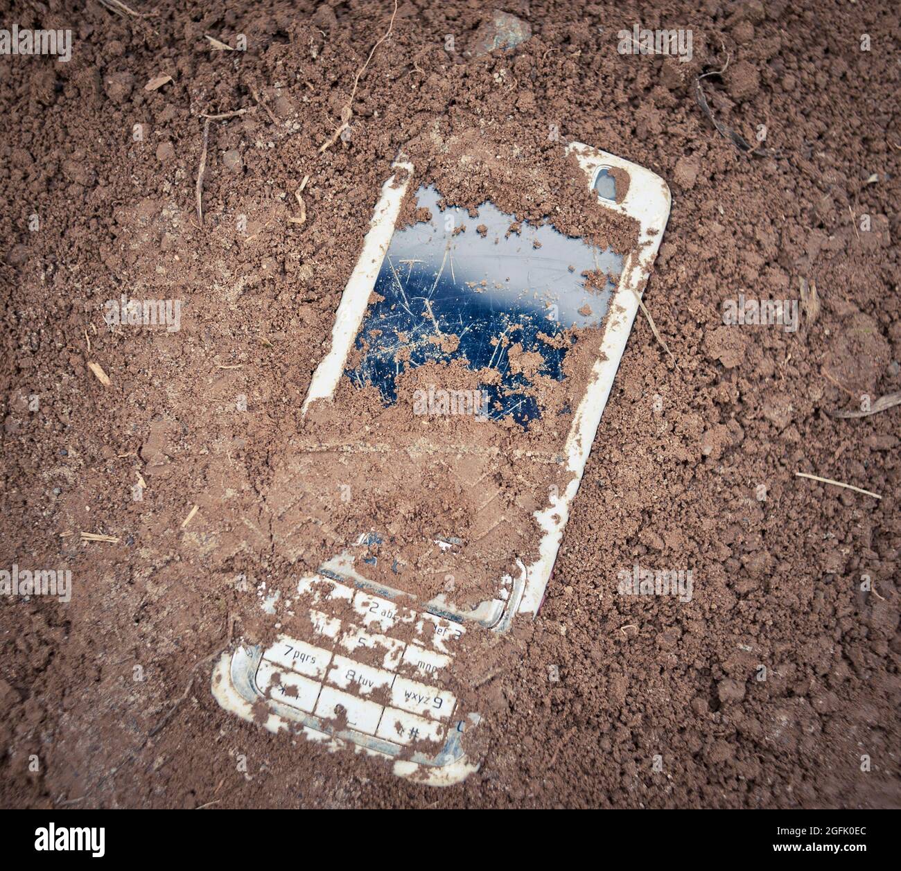 Buried old mobile phone Stock Photo - Alamy