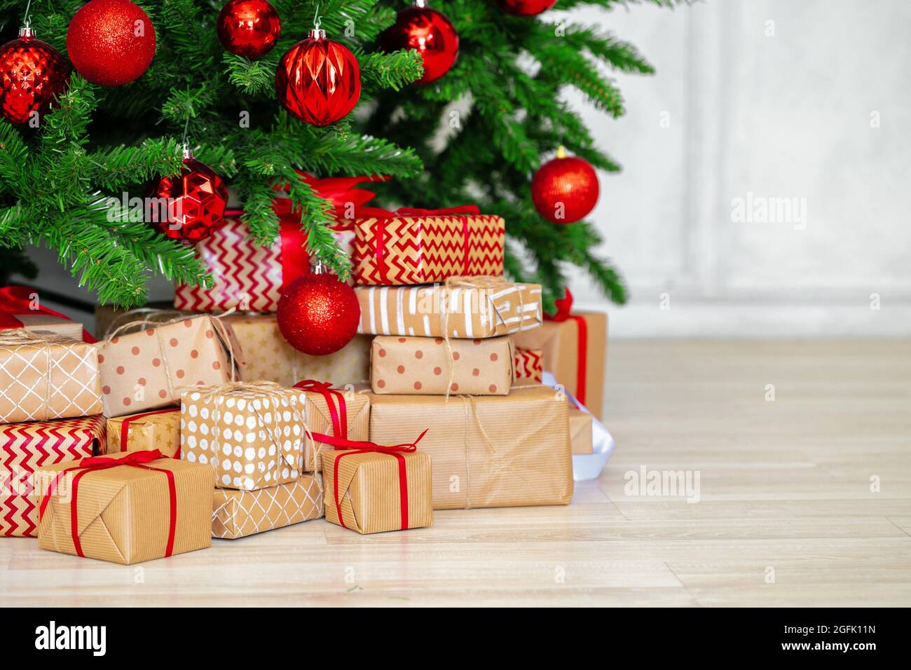 Stack of wrapped presents under Christmas tree Stock Photo - Alamy