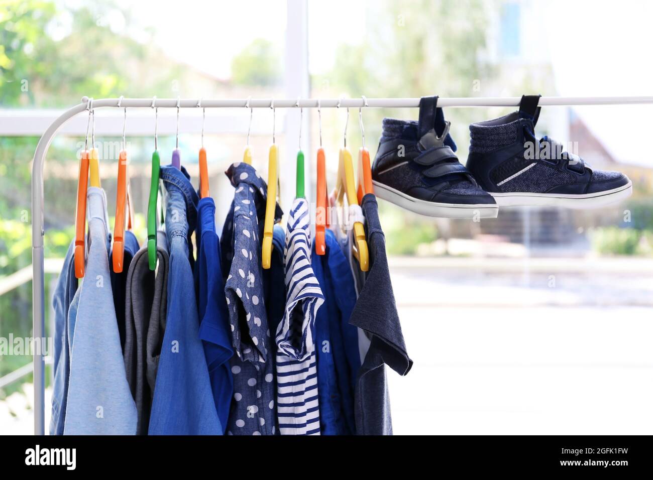 Clothes hanging on rack, closeup Stock Photo - Alamy