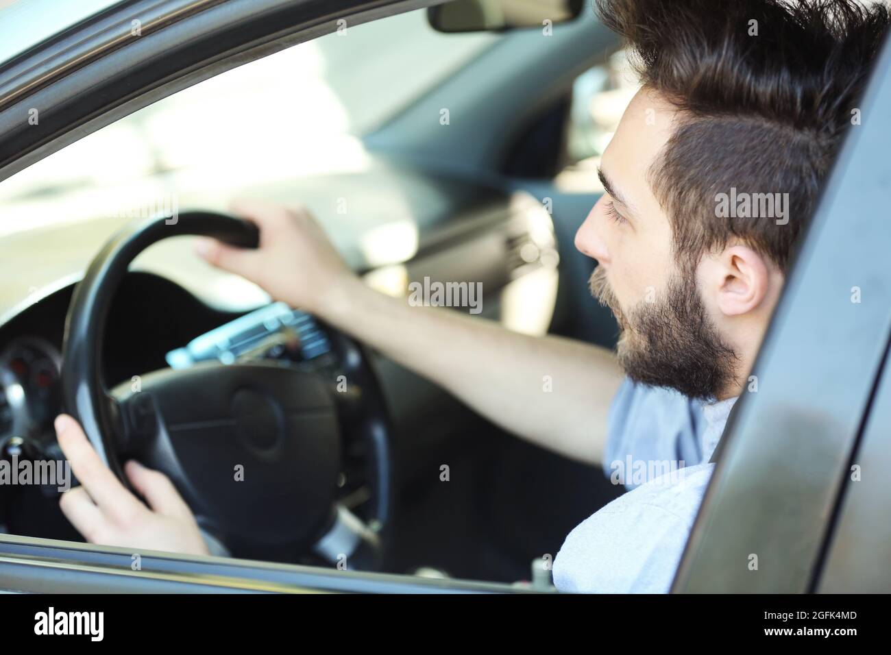 Young successful man driving car Stock Photo - Alamy