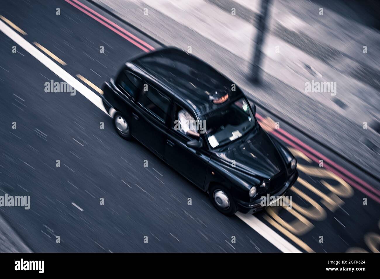 London Taxi driving in the street Stock Photo - Alamy