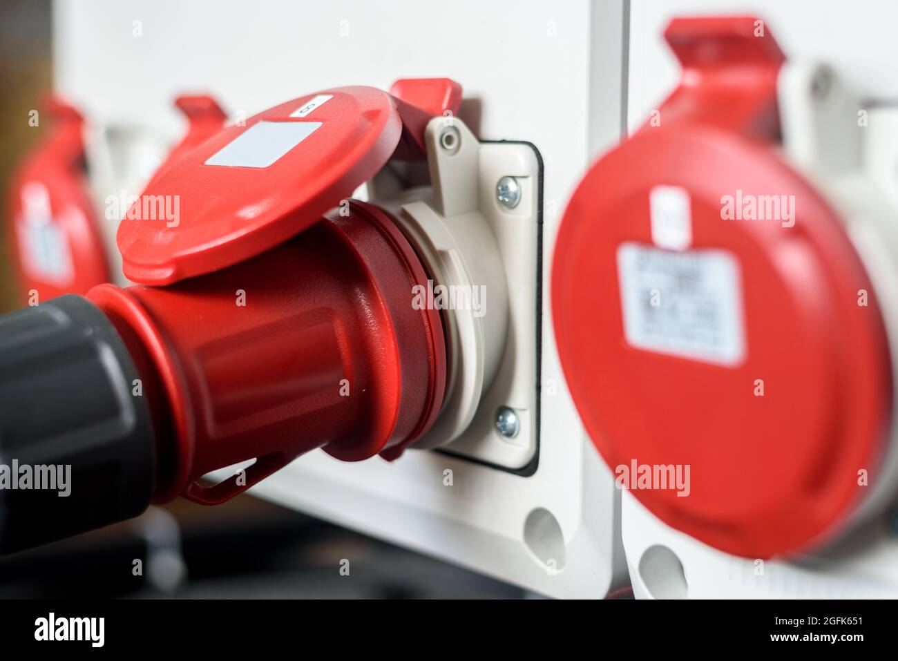 Industrial sockets and plug on distribution board. Construction site electricity, temporary ...