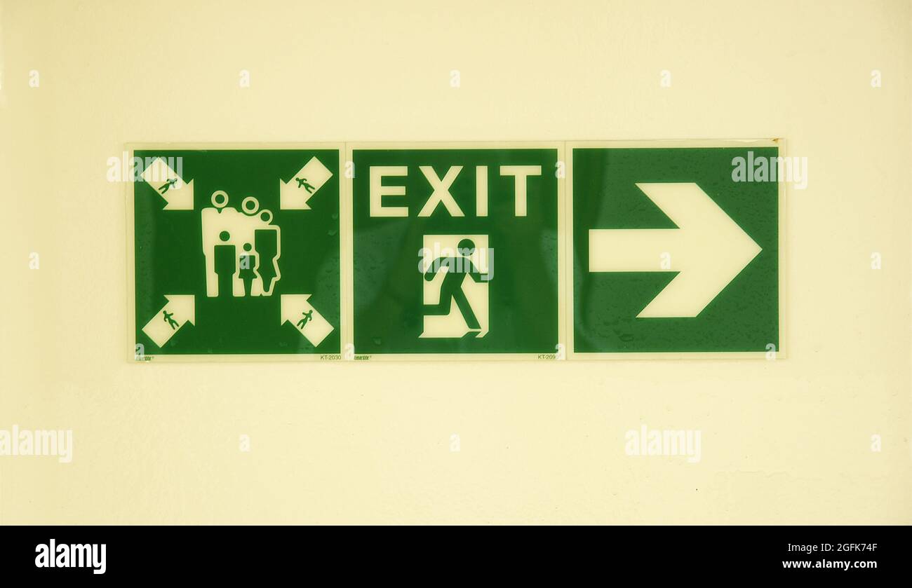 signpost indicating the direction to exit and meeting point Stock Photo ...