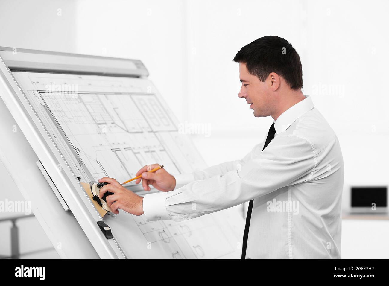 Young creative male engineer making project on drawing board Stock ...