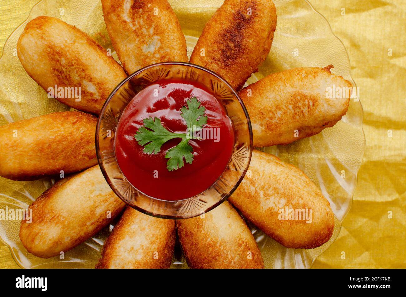Fried Bread Rolls with Tomato sauce, served in glass plate on Golden ...