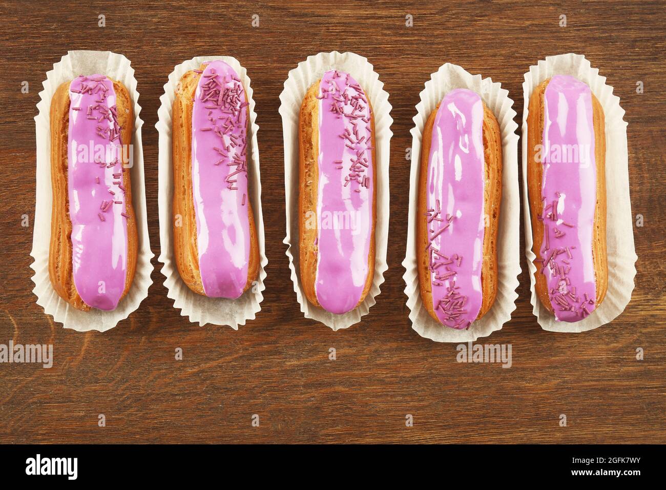 Delicious eclairs on wooden table, top view Stock Photo - Alamy