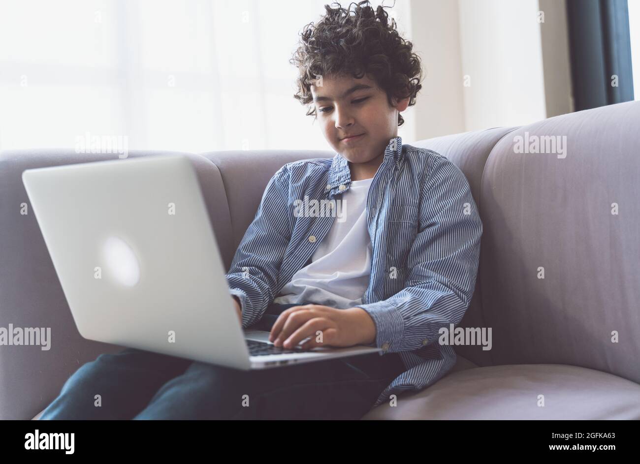 little kid studying on his laptop. Concept about childhood and ...