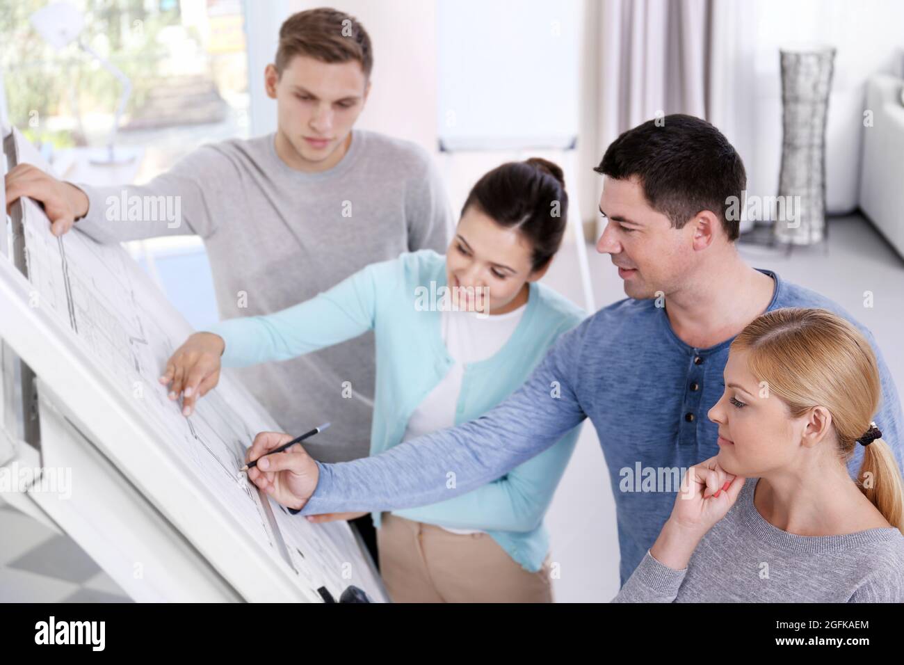 Team of young creative engineers working with new architectural project ...