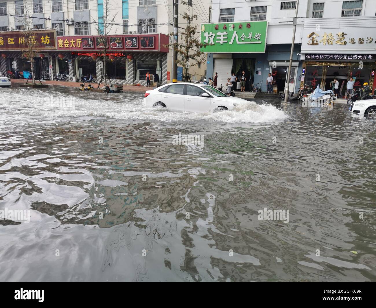 People commute through the waterlog caused by heavy rain in Lianyungang ...