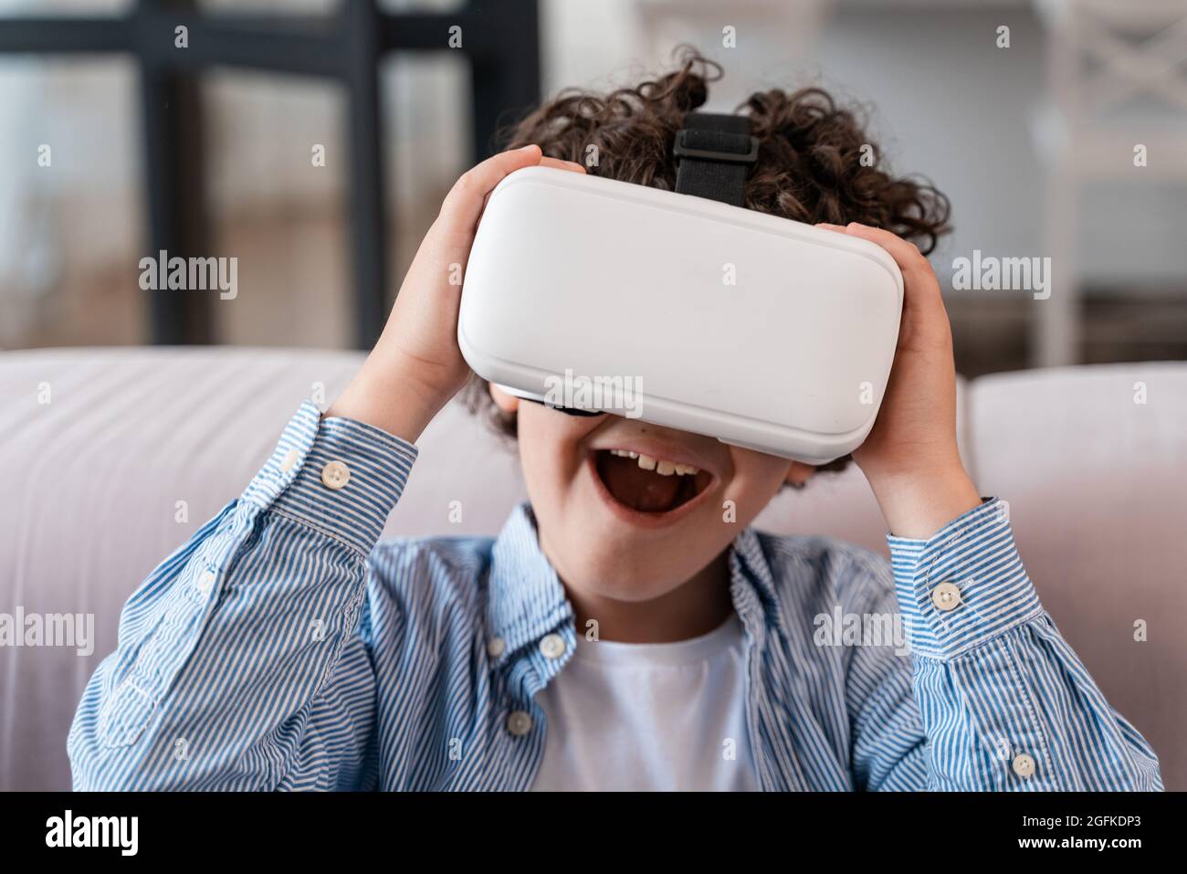 little kid using vr glasses. Concept about childhood and technology ...