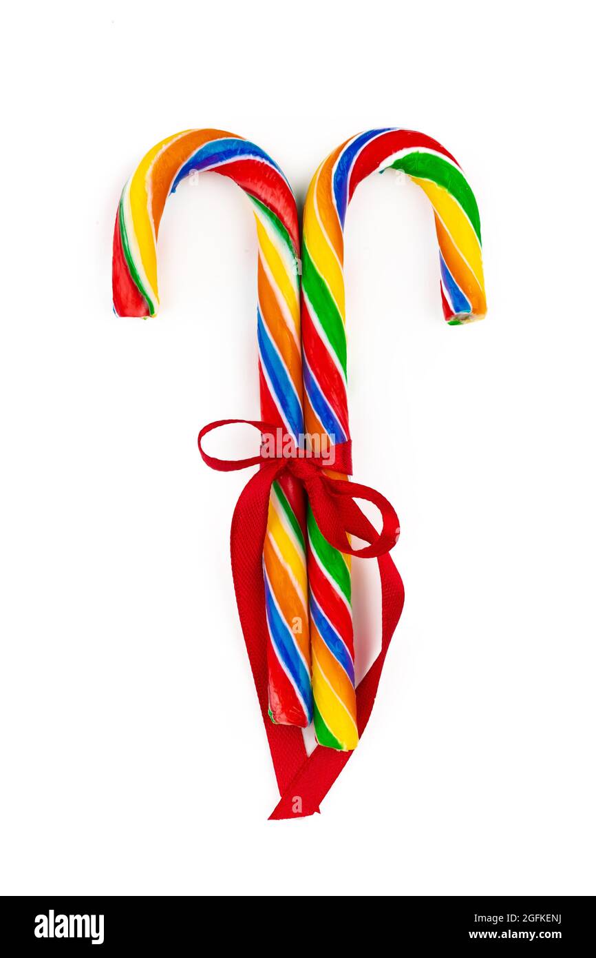 Rainbow colored candy cane isolated on white background Stock Photo - Alamy
