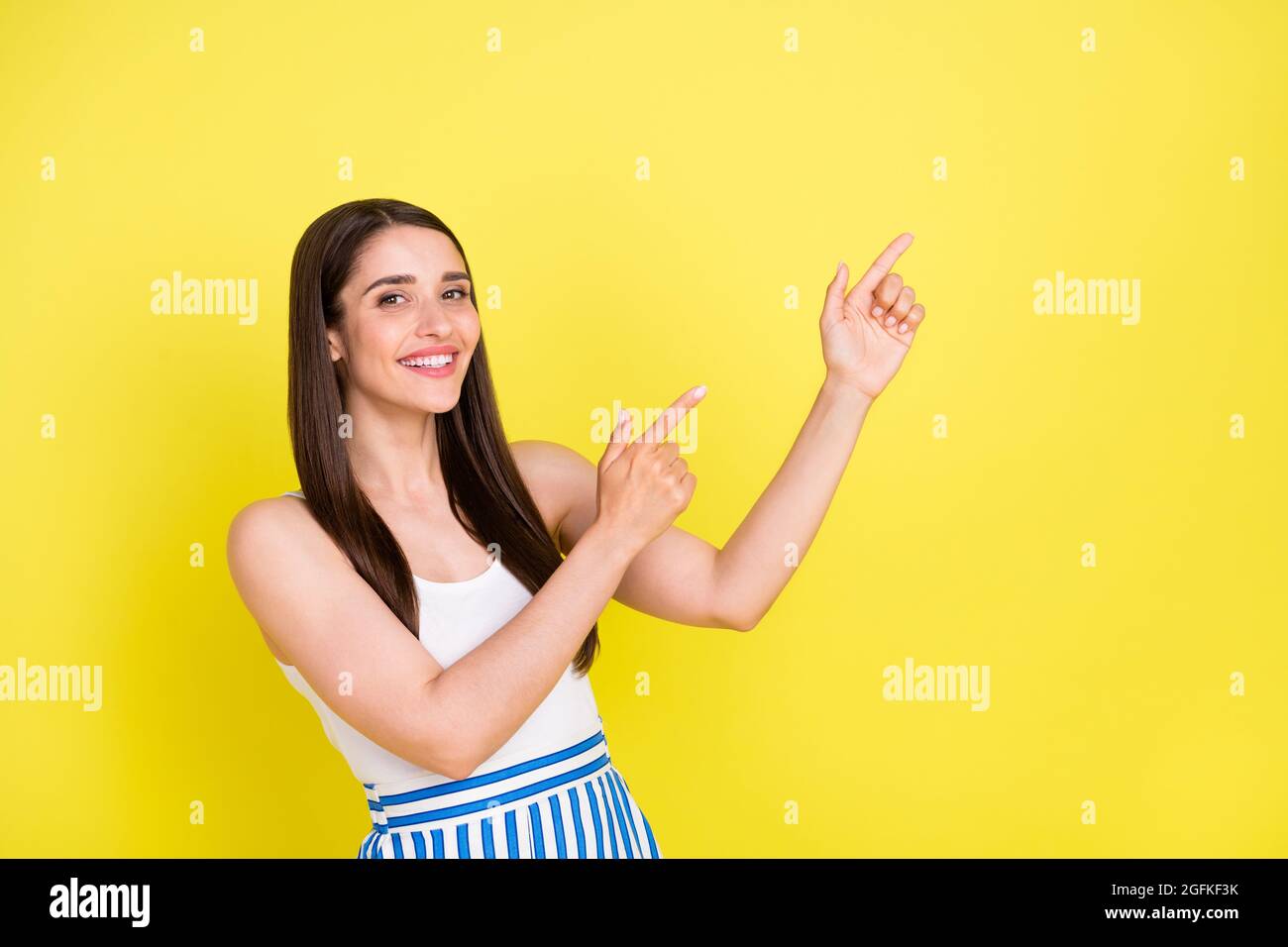 Portrait of attractive cheerful girl showing copy empty space ad advert ...