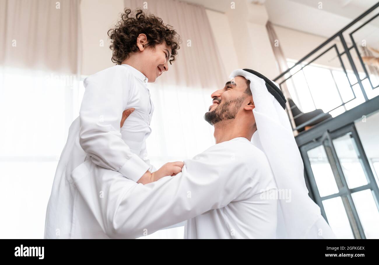 happy family spending time together. Arabian father and his son playing ...