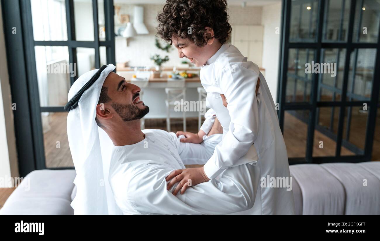 happy family spending time together. Arabian father and his son playing ...