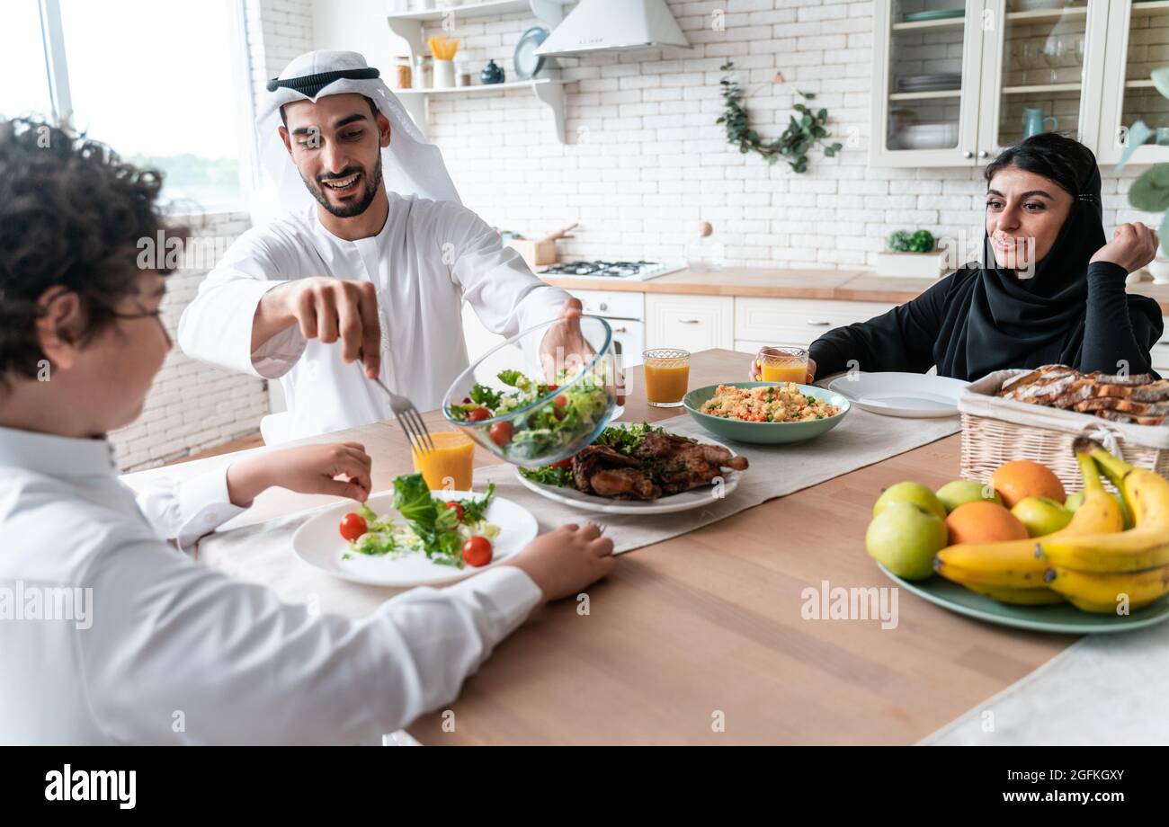 happy family from arab united emirates eating together and celebrating ...
