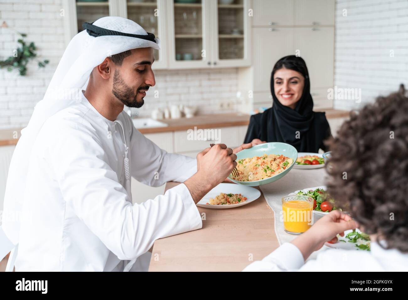 happy family from arab united emirates eating together and celebrating ...