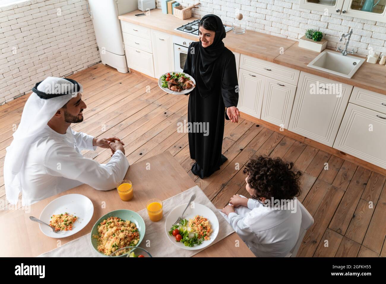 happy family from arab united emirates eating together and celebrating ...