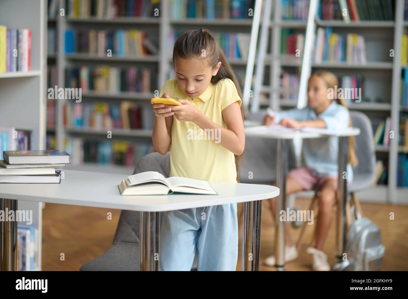 Two schoolchildren doing their homework at the library Stock Photo - Alamy Two schoolchildren doing their homework at the library Stock Photo - Alamy