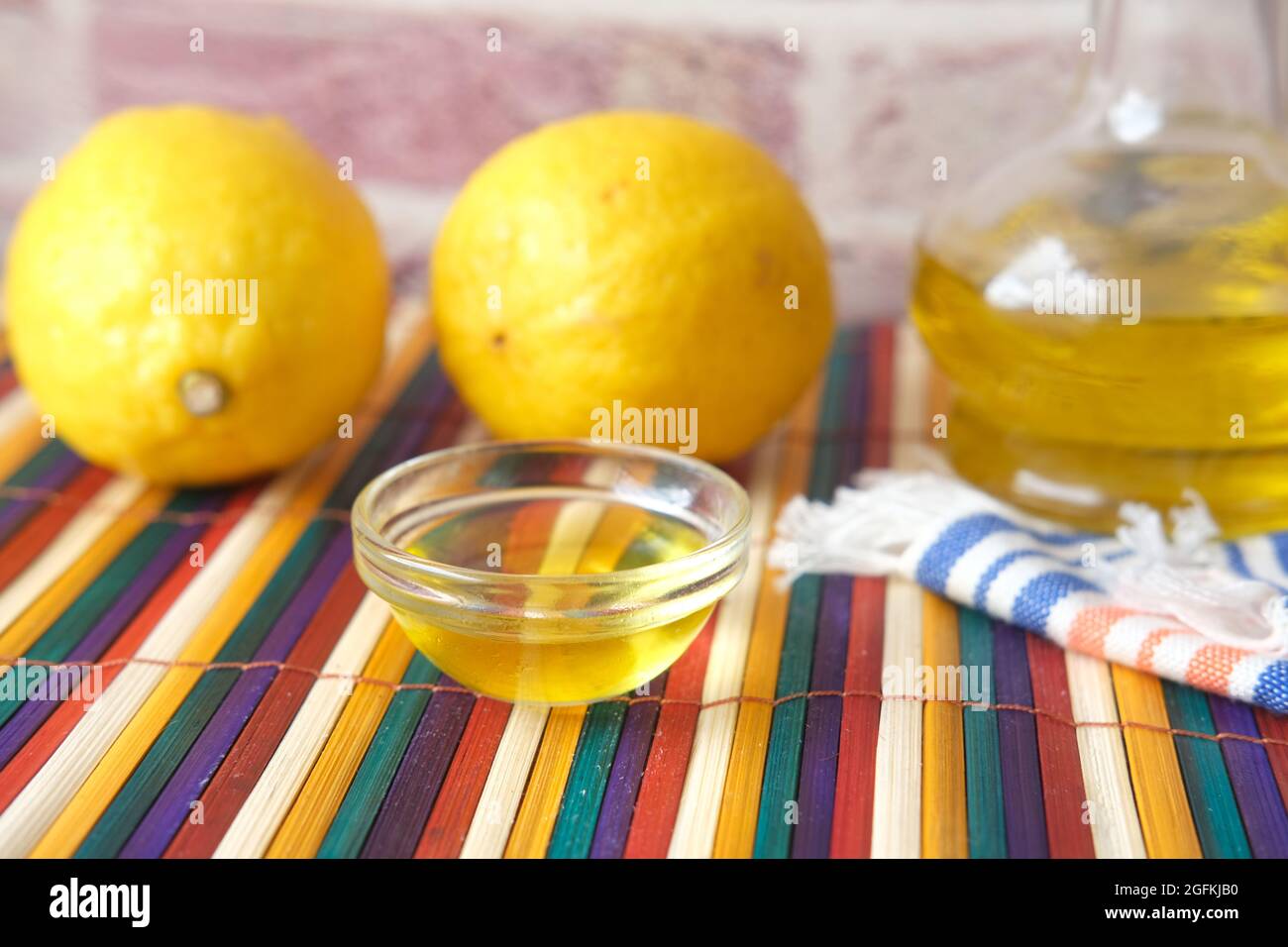glass container of oil and lemon on table Stock Photo - Alamy